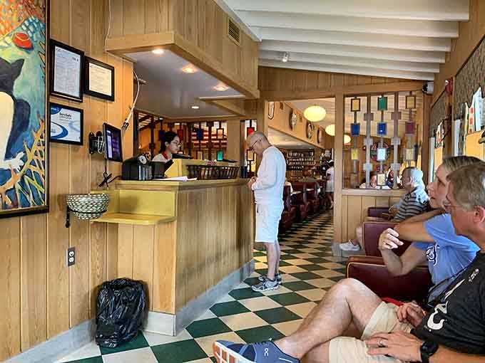 The lobby's checkered floor and wood paneling whisper promises of the comfort food waiting just beyond.