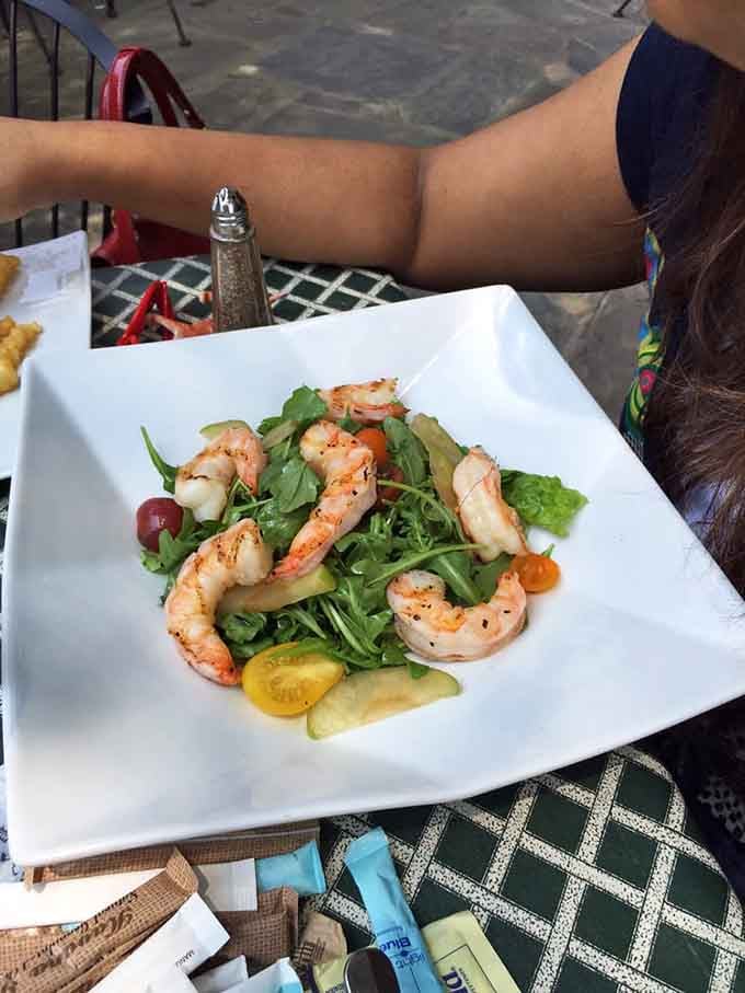 Shrimp salad so fresh and vibrant it practically whispers "eat me" from its pristine white plate.