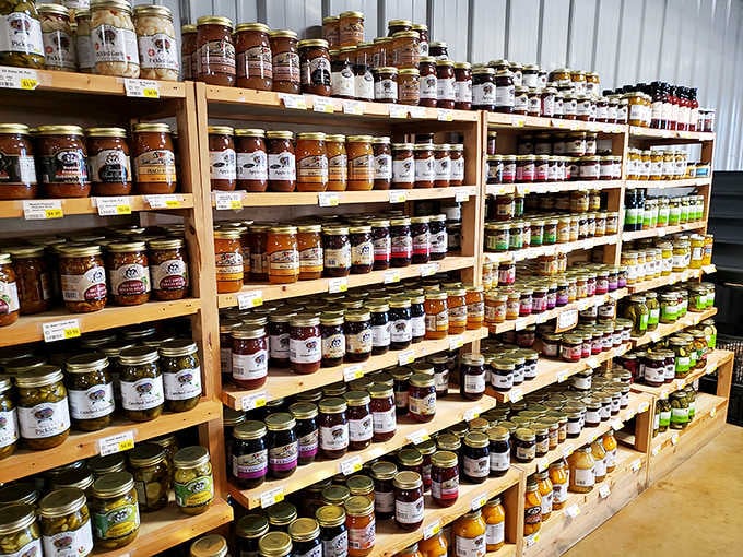 Jams and jellies in every flavor imaginable line these wooden shelves like a rainbow made entirely of preserves.