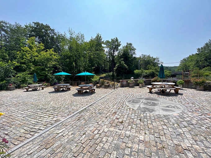 Cobblestone patio seating by the falls offers the perfect spot to enjoy your meal surrounded by nature.