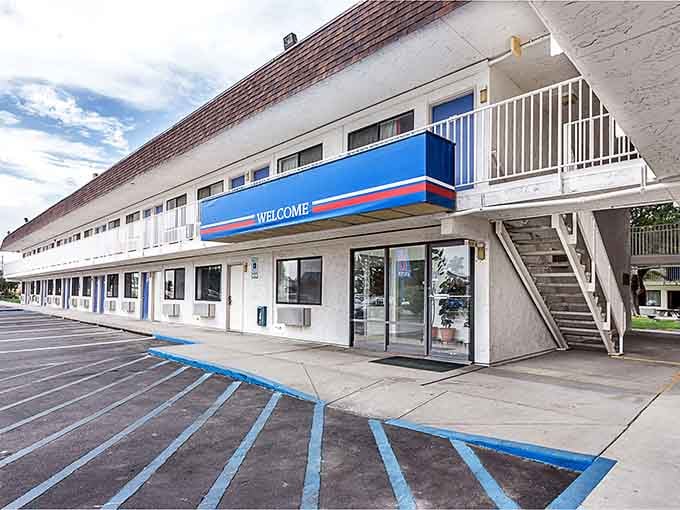 The iconic blue and red stripes signal affordable rest for weary travelers, no frills but plenty of value included.