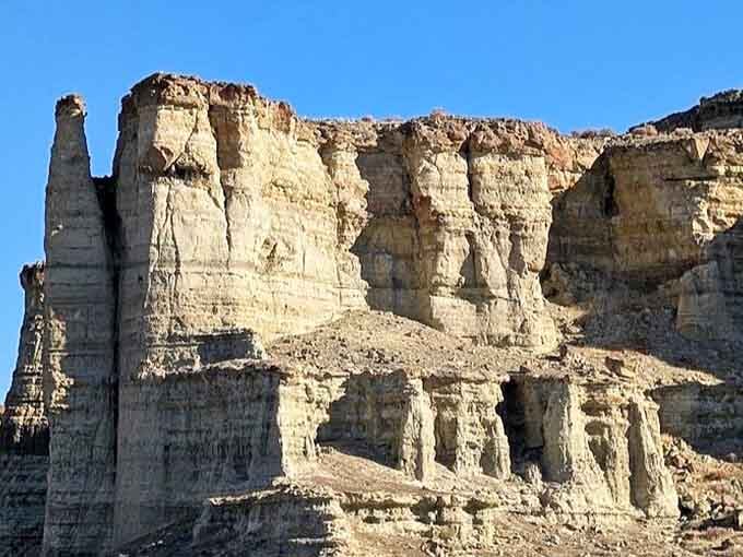 Under brilliant blue skies, the pillars reveal their full glory, standing tall like nature's own version of ancient Roman columns.