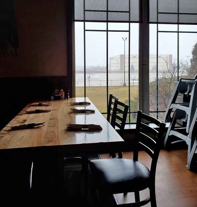 Tables positioned near expansive windows ensure every seat gets a decent view of the airport action happening outside.