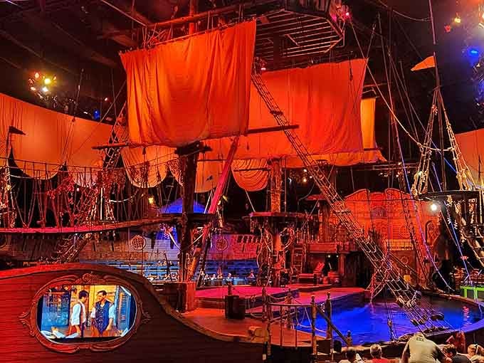 That massive ship dominates the performance space, complete with rigging that performers actually climb during the show.
