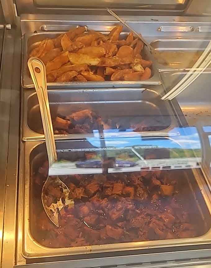 The steam trays hold treasures: golden fried chicken and pulled pork waiting to make someone's day infinitely better.