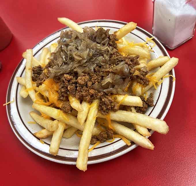 Chili cheese fries piled high enough to feed a small army, or one very determined person with priorities.