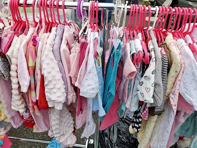 Tiny clothes on pink hangers, because even babies deserve bargains on their adorable little outfits.