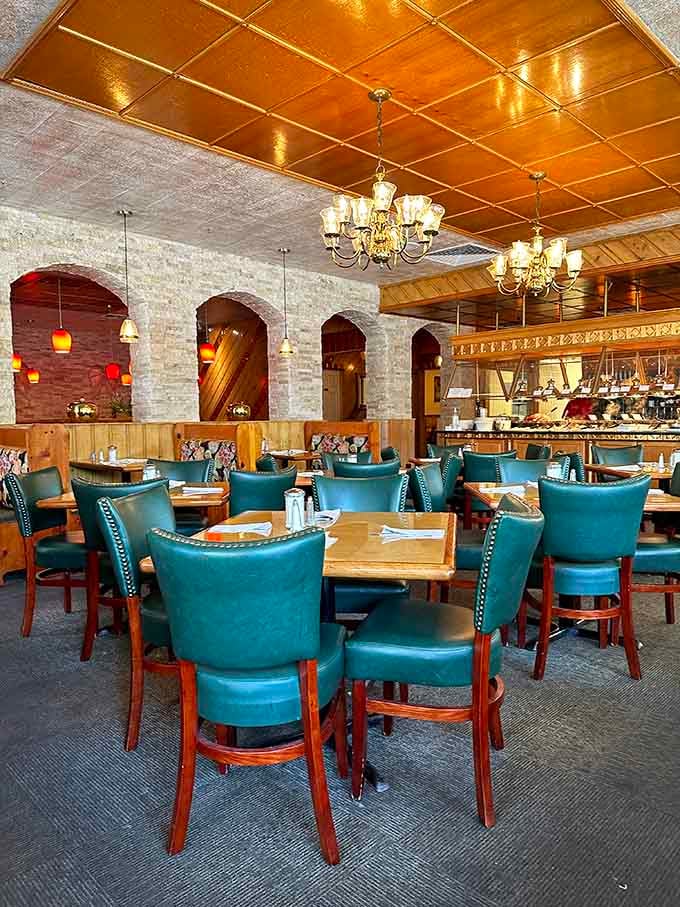 Teal chairs and golden ceilings creating an atmosphere that's somehow both fancy and wonderfully unpretentious at once.