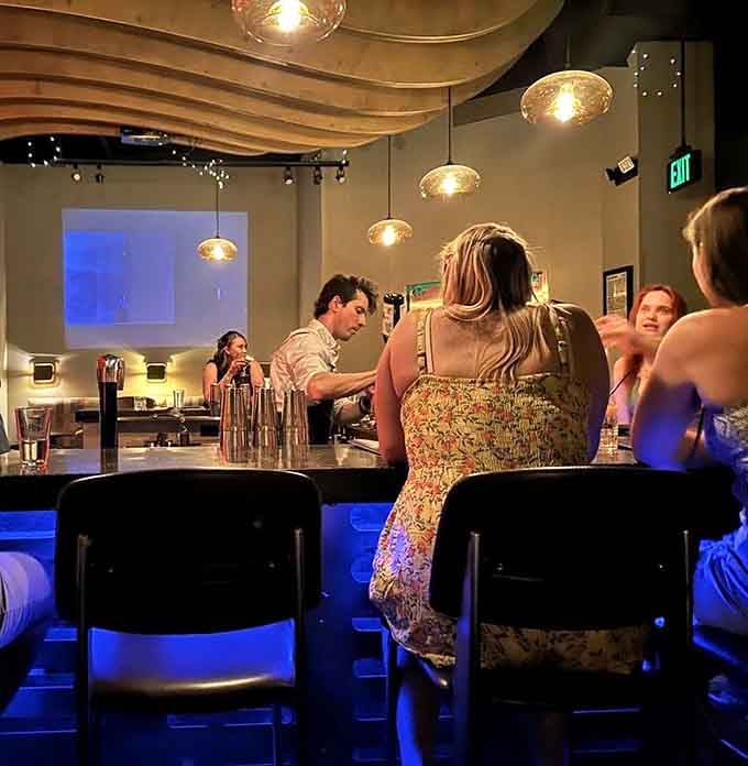 The sleek bar setup welcomes guests into a space where craft cocktails meet interstellar design and creativity.