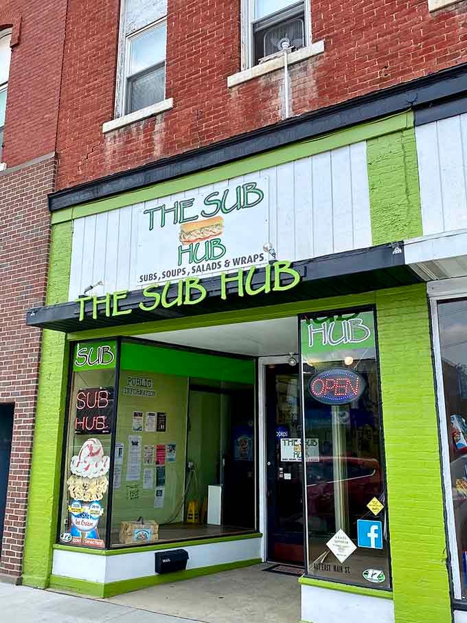 The Sub Hub's bright green storefront practically shouts its presence, promising satisfying meals without the franchise price markup.