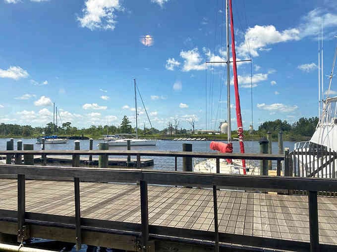The deck overlooks the Sampit River where boats drift by, reminding you that some people actually live this life daily.