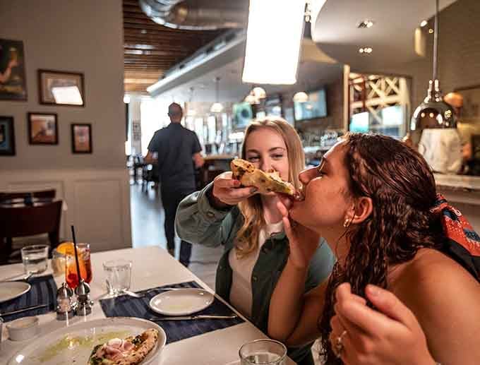 Pure joy captured: sharing authentic Neapolitan pizza with someone you love makes everything taste better somehow.