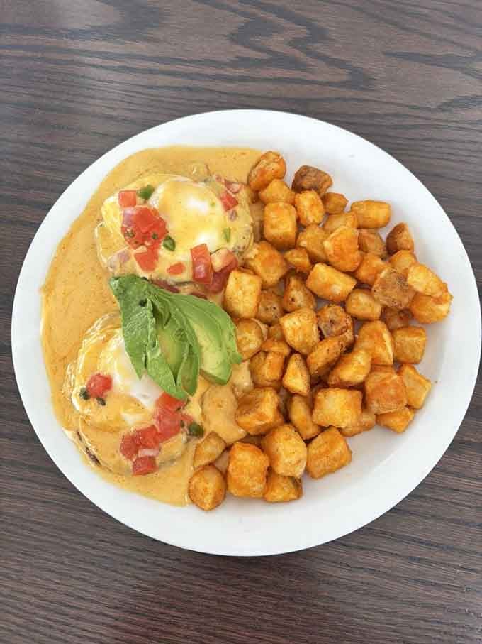 Eggs Benedict with a side of crispy potatoes, because breakfast should always feel like a celebration.