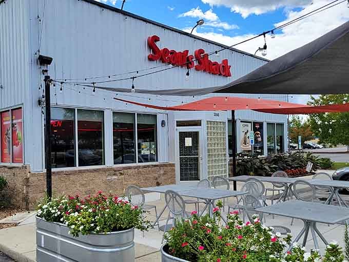 Outdoor seating with flowers and string lights transforms a simple meal into an experience that feels more expensive than it actually is.