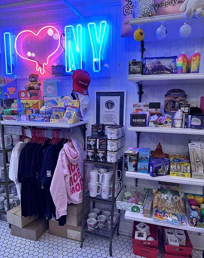 The neon "I Love NY" sign glowing above shelves of sweet souvenirs captures the city's spirit in electrified blue brilliance.