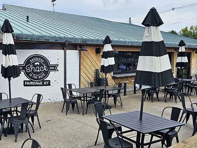 Outdoor patio seating with striped umbrellas lets you enjoy Kentucky weather while devouring world-class barbecue bliss.