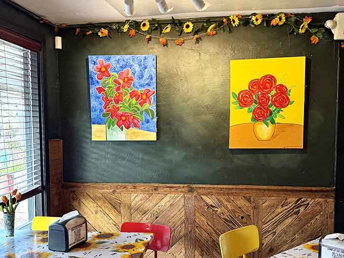 Bold floral paintings pop against charcoal walls, transforming this cozy space into an unexpected art gallery with great food.
