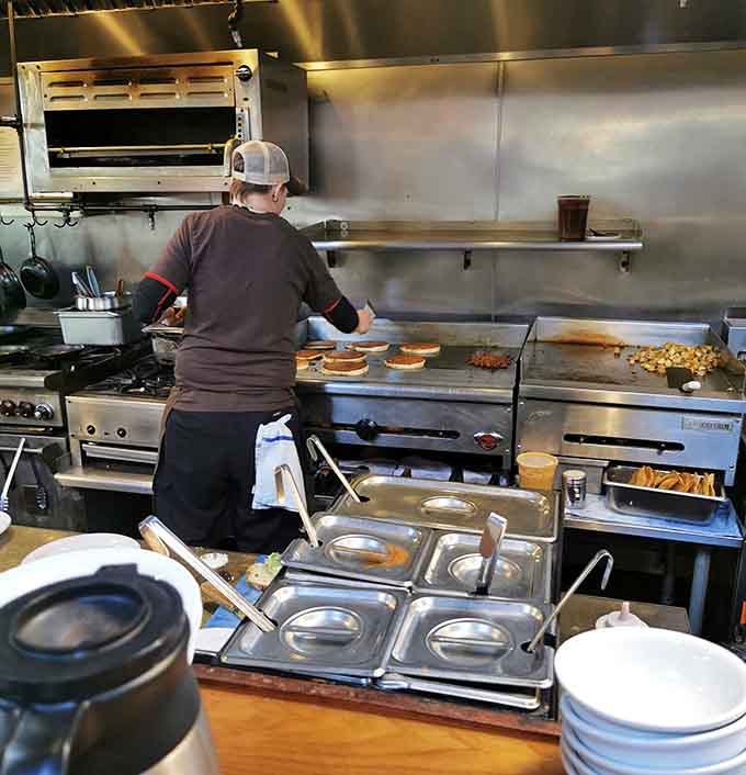 Behind the scenes, skilled hands work the griddle with the precision of a conductor leading a breakfast symphony.