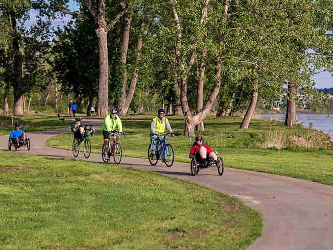 Riverside trails invite cyclists and walkers to enjoy the waterfront without fighting traffic or paying exorbitant parking fees for nature.