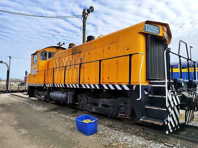 This bright yellow diesel switcher represents the transition era when steam gave way to more practical but less romantic power.