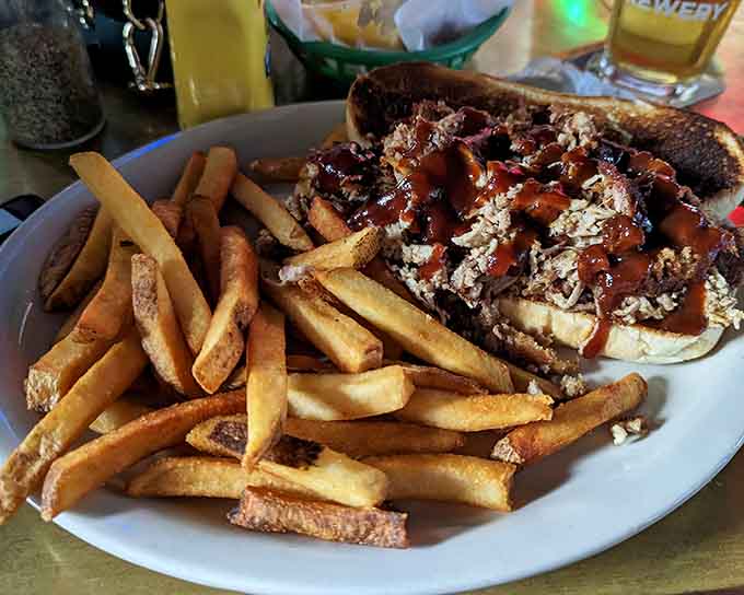 This open-faced steak sandwich drowning in savory goodness with a pile of fries is comfort food that doesn't apologize for its richness.