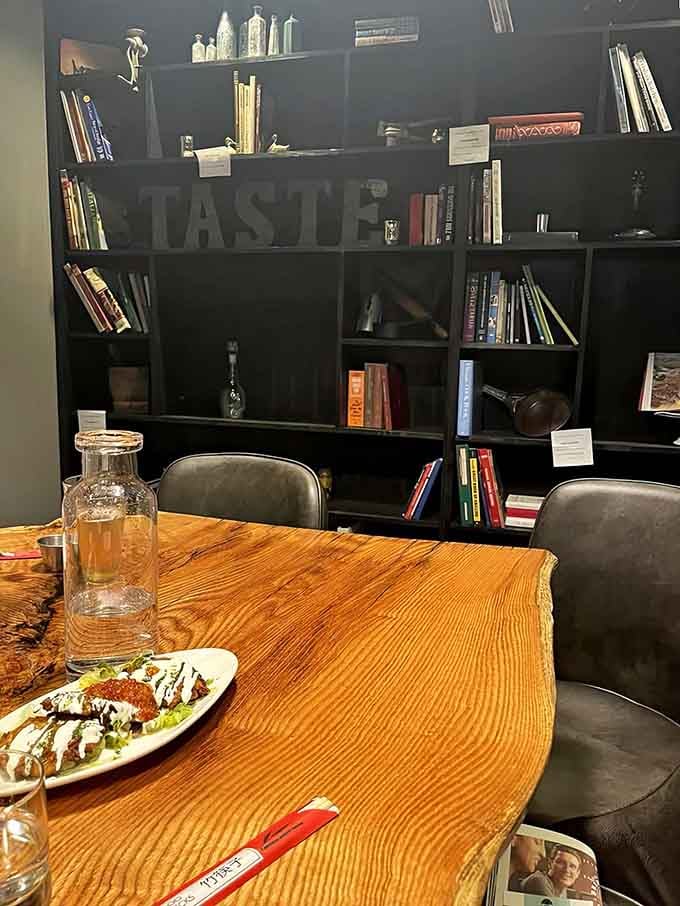 A cozy private nook with bookshelves that suggests this place values both good reading and even better eating equally.