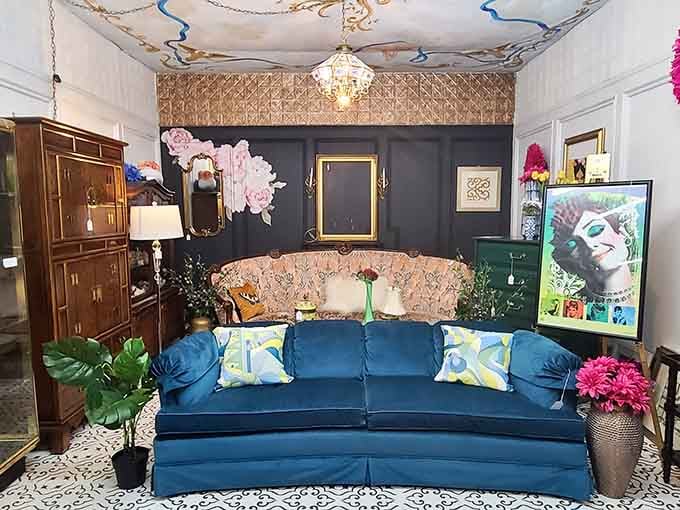 That jewel-toned velvet sofa anchors a maximalist dream room where more is definitely more and boring never existed.