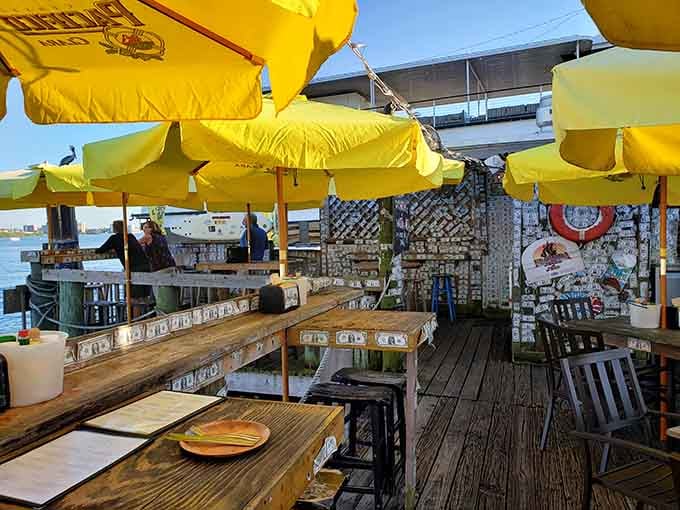 Yellow umbrellas shading wooden tables on the dock create the perfect spot for eating shrimp and watching boats drift lazily by.