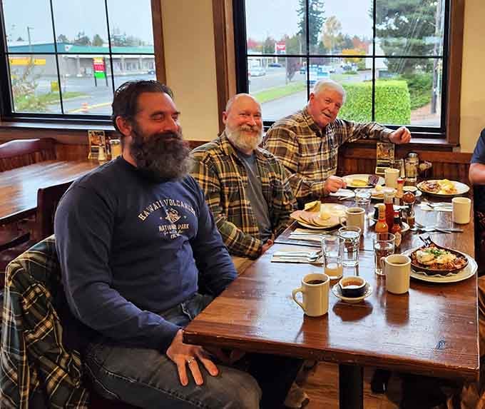 Happy diners enjoying their breakfast bounty, proof that good food creates genuine smiles and satisfaction.
