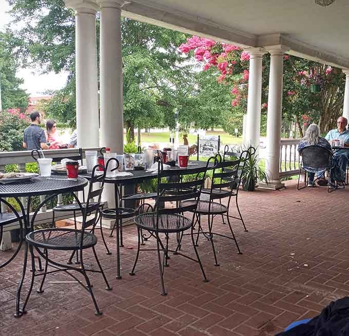 Porch dining under the columns lets you enjoy Southern hospitality with a side of fresh air and people-watching.