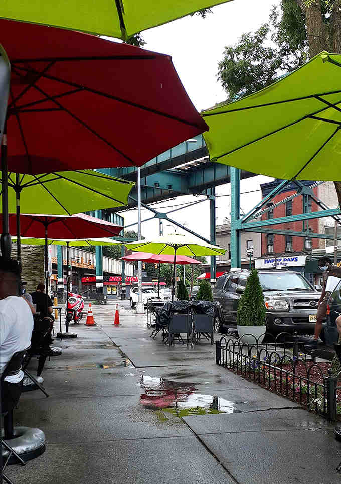 Outdoor seating under colorful umbrellas, because sometimes breakfast tastes better with a side of fresh air.