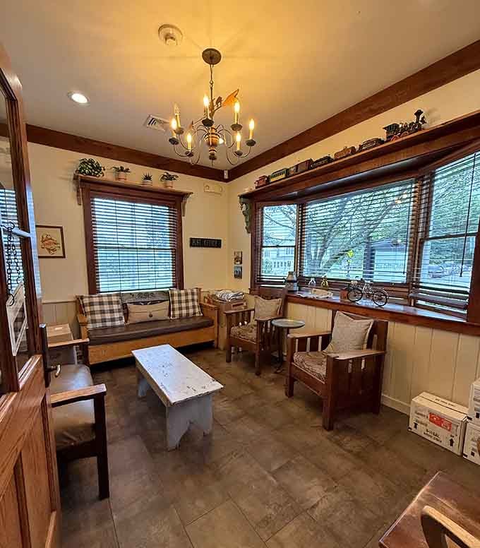 The main room where community happens one cup at a time, complete with chandeliers that add unexpected elegance.