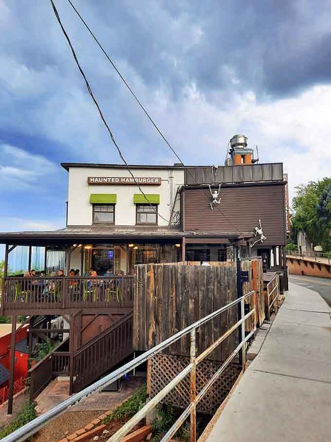 The building clings to the mountainside like it grew there, defying logic and delivering unforgettable dining experiences.