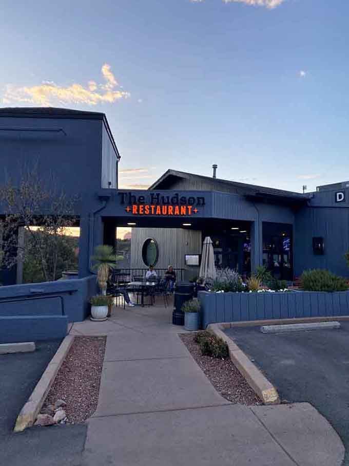 The modern exterior hints at the culinary treasures waiting inside, with Sedona's red rocks providing nature's perfect backdrop.