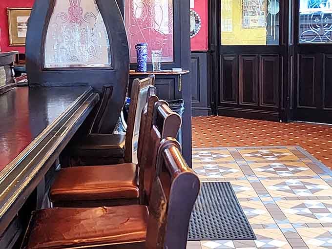 Counter seating with colorful stained glass windows makes even solo dining feel like you've scored the best seat available.