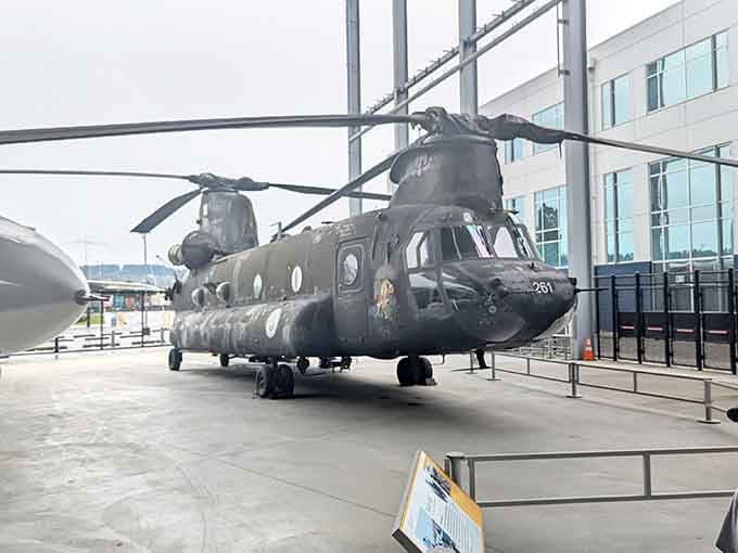 The Chinook helicopter sits ready for action, its twin rotors having served in conflicts spanning multiple generations.