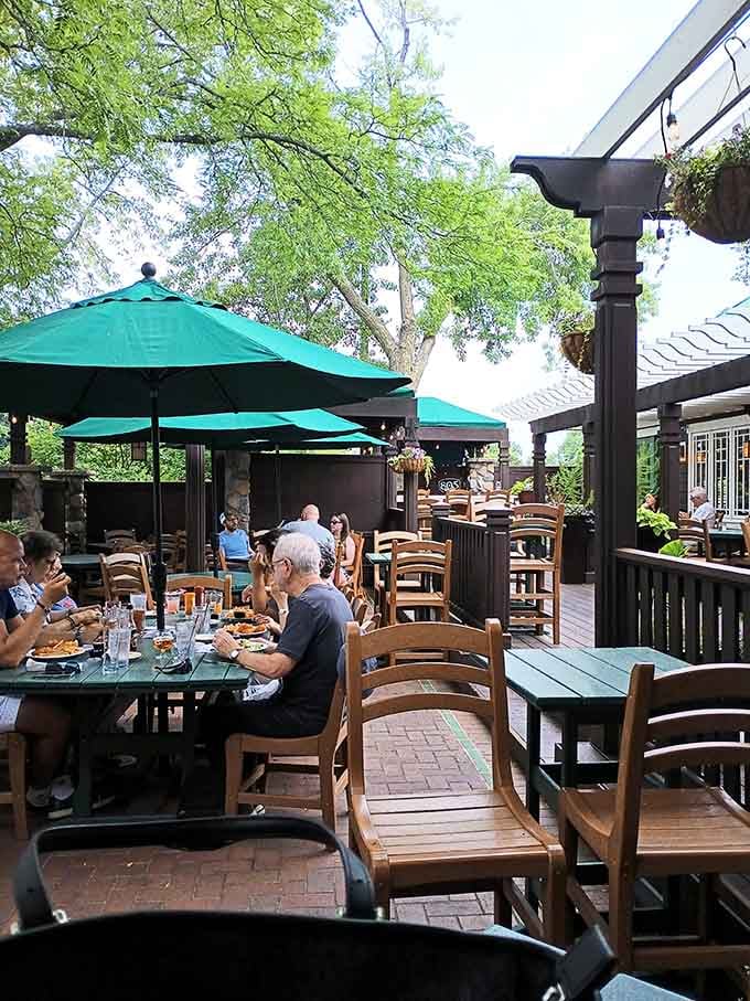 The spacious patio with green umbrellas offers the ideal setting for warm weather dining and people watching.