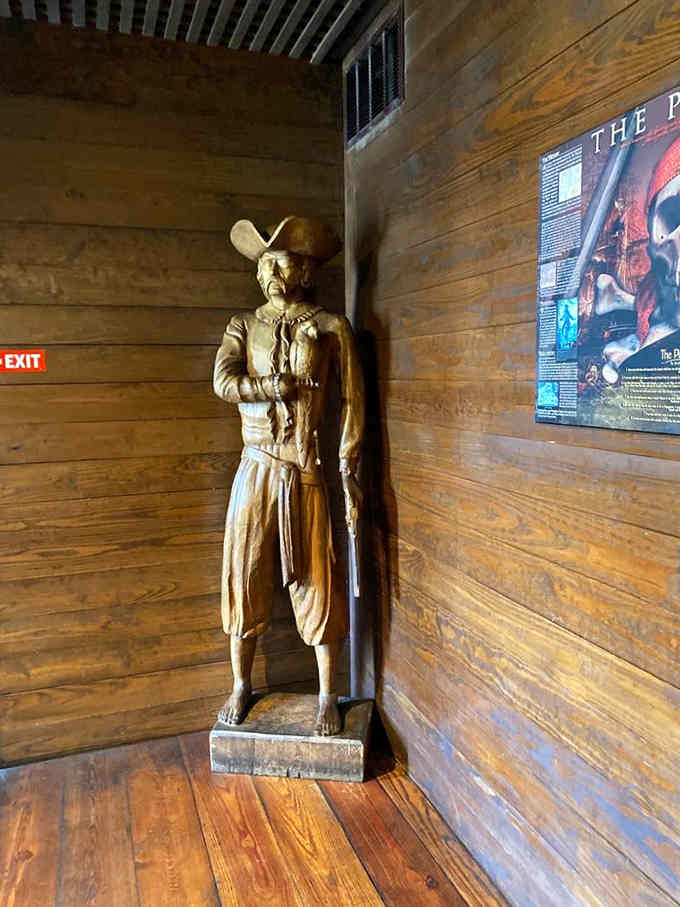 This carved buccaneer stands eternal watch, greeting visitors with silent stories etched in weathered wood and knowing expression.