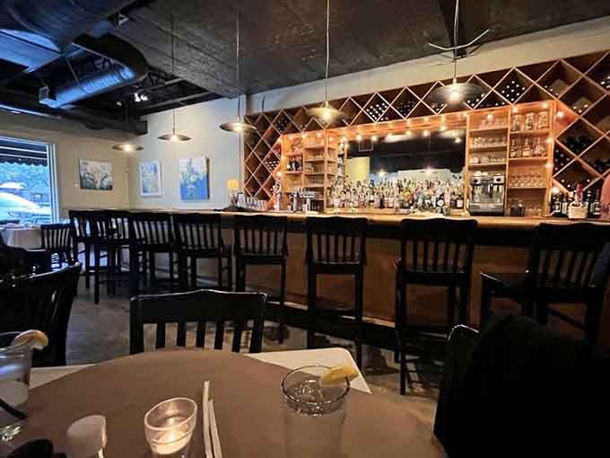 The well-stocked bar area beckons with promise, featuring pendant lights and enough bottles to satisfy any cocktail craving imaginable.