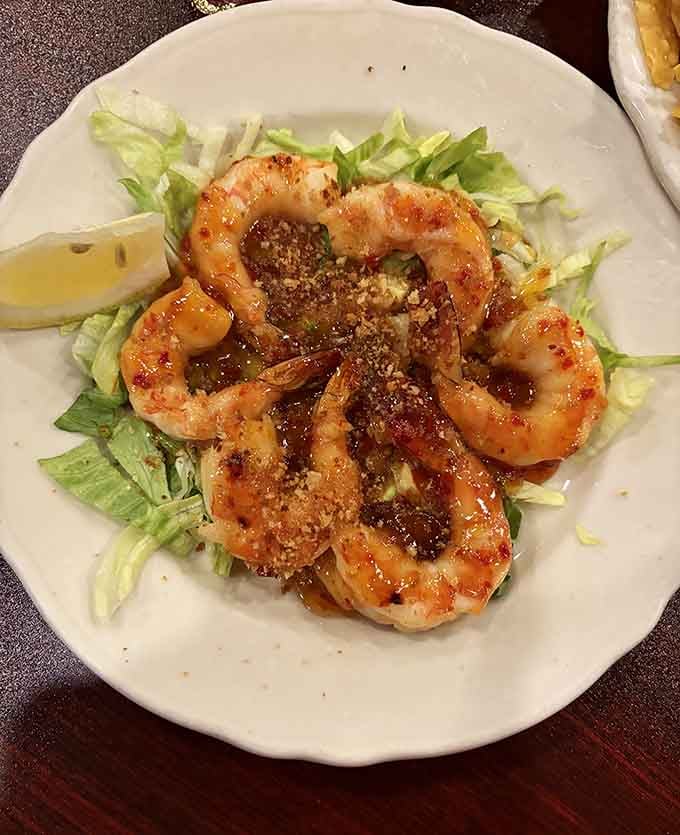 Plump shrimp arranged over crisp lettuce with a sprinkle of parmesan, looking like they jumped from ocean to plate this morning.