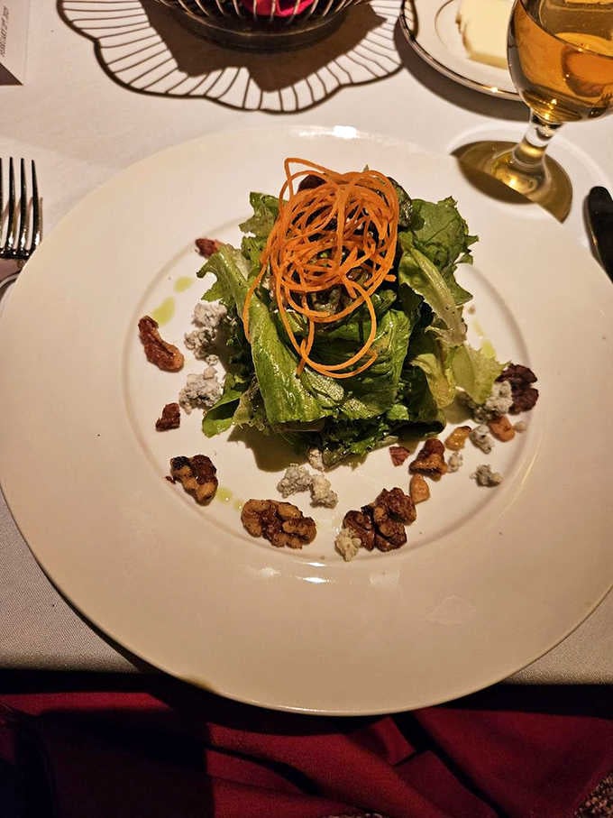 This salad topped with crispy carrot ribbons proves that even the greens get the gourmet treatment at this establishment.