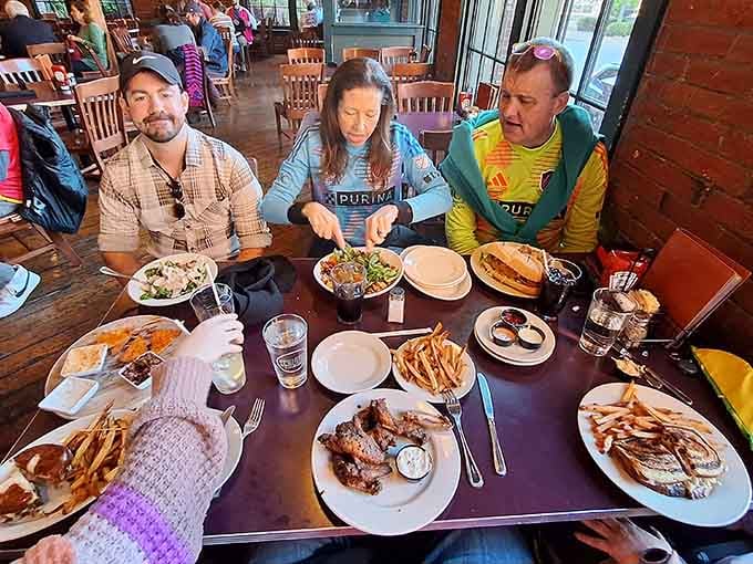 Happy diners surrounded by enough food to feed a small army or three very hungry people.