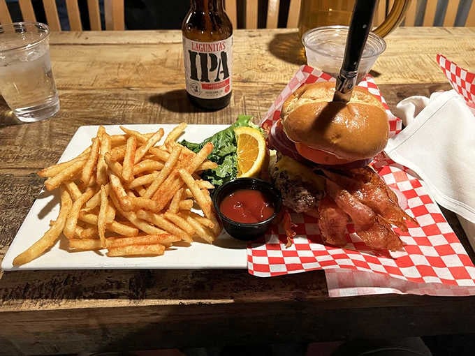 A bacon cheeseburger with crispy fries and a local IPA&mdash;the kind of meal that makes road trips worthwhile.