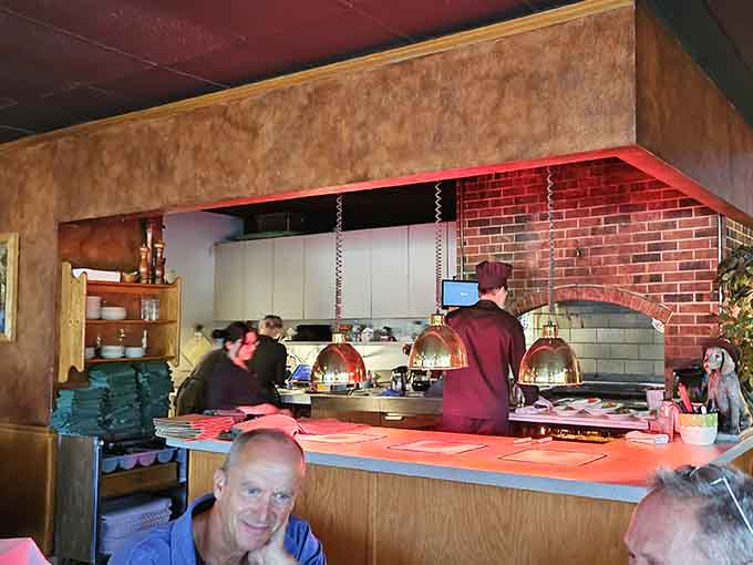 The open kitchen with its brick archway lets you watch the magic happen&mdash;dinner and a show.