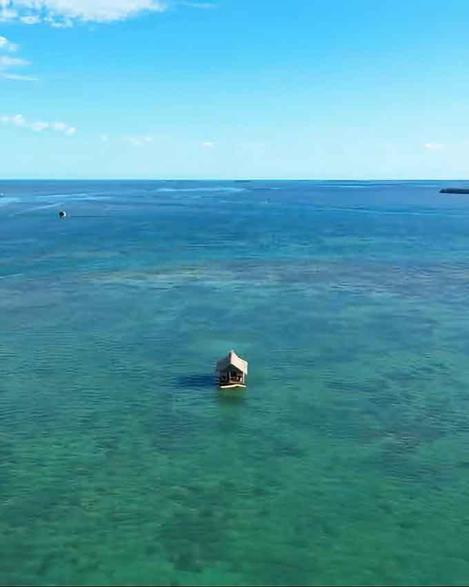 Aerial views reveal just how perfectly isolated this floating gem sits in those impossibly blue waters.