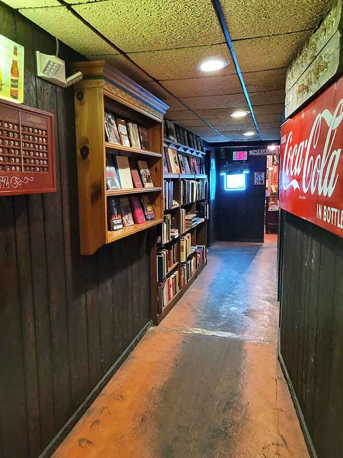 Vintage Coca-Cola signs and shelves of books create a nostalgic hallway that feels like stepping back in time.
