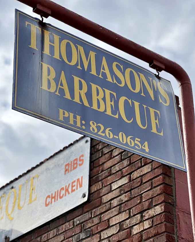 This weathered sign has been calling to hungry travelers like a barbecue beacon for generations now.