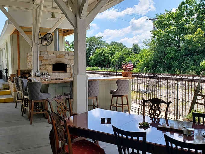 The covered patio with its wood-fired pizza oven promises al fresco dining with serious culinary credentials.