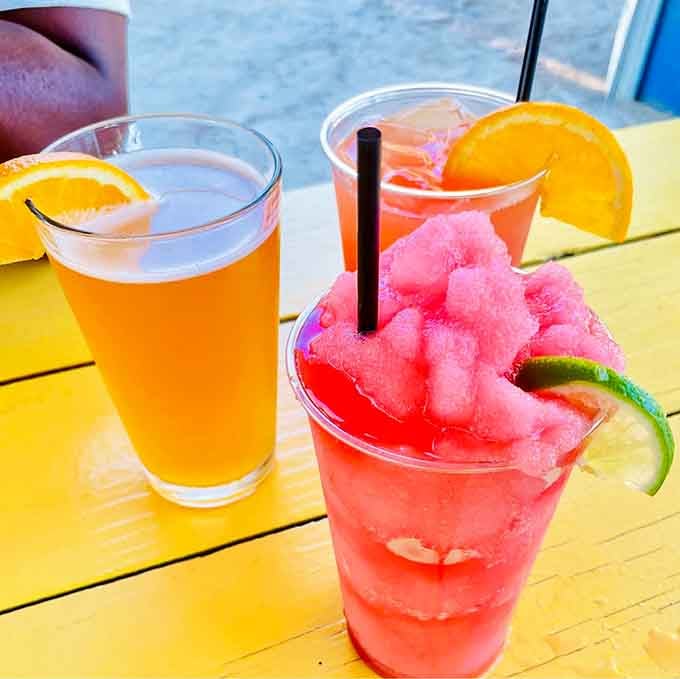 Frozen drinks in sunset colors remind you that paradise is sometimes just a cocktail and attitude away.