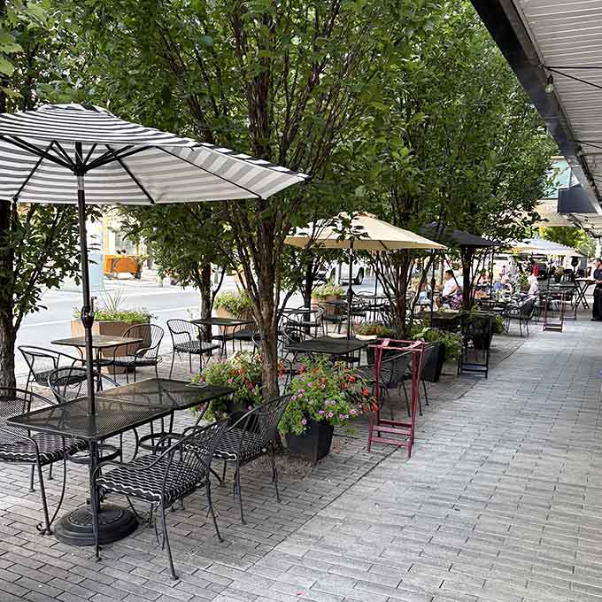 Sidewalk dining under umbrellas where people-watching pairs perfectly with exceptional Italian food and wine.